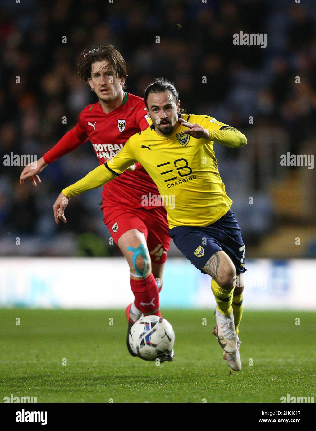 Oxford United's Ryan Williams (right) dribbles away from AFC Wimbledon ...