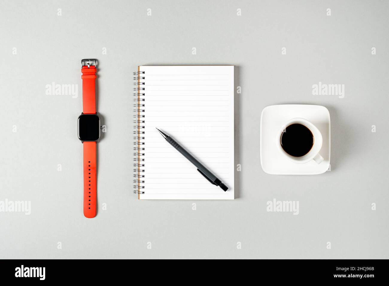 Notepad, watch, pen and a cup of coffee isolated on light gray ...