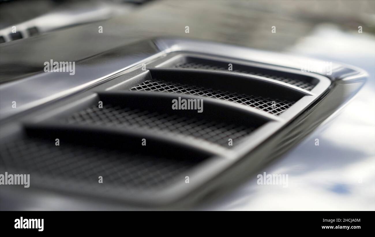 Close up for detail of air vents on the bonnet of a modern black car ...