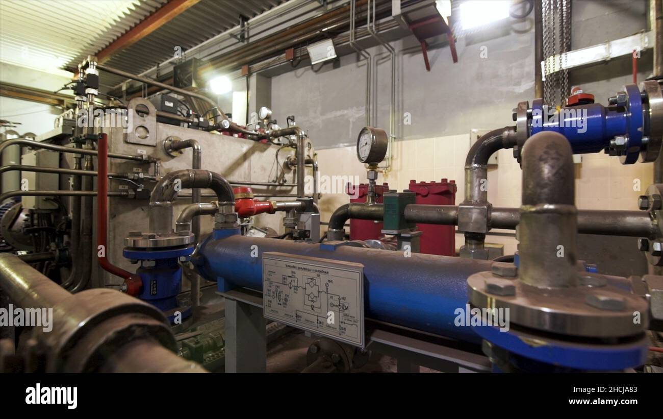 Large industrial boiler room, pipes of central heating system and water ...