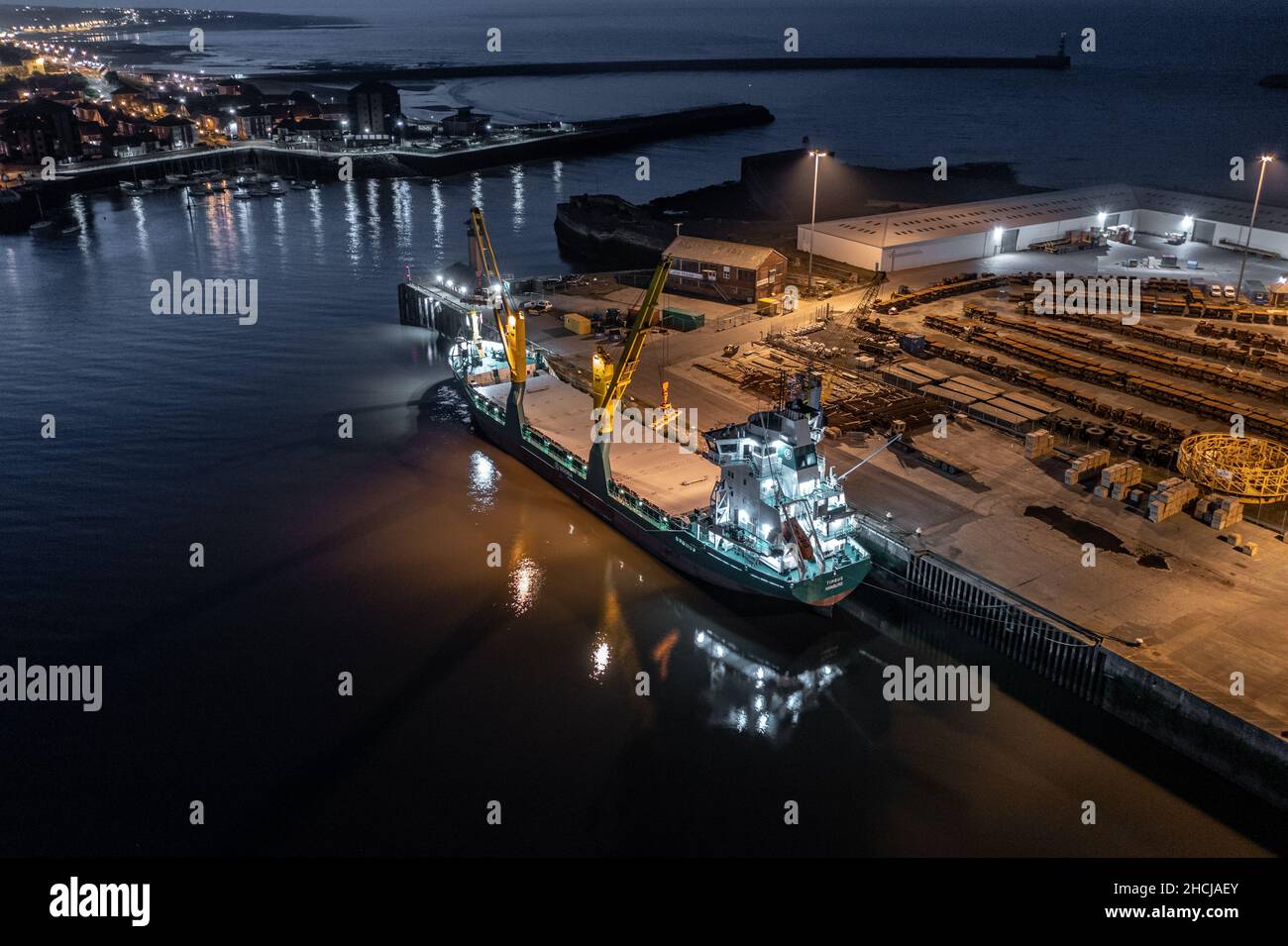 Ship Offloading Cargo at Docks at Night Stock Photo - Alamy