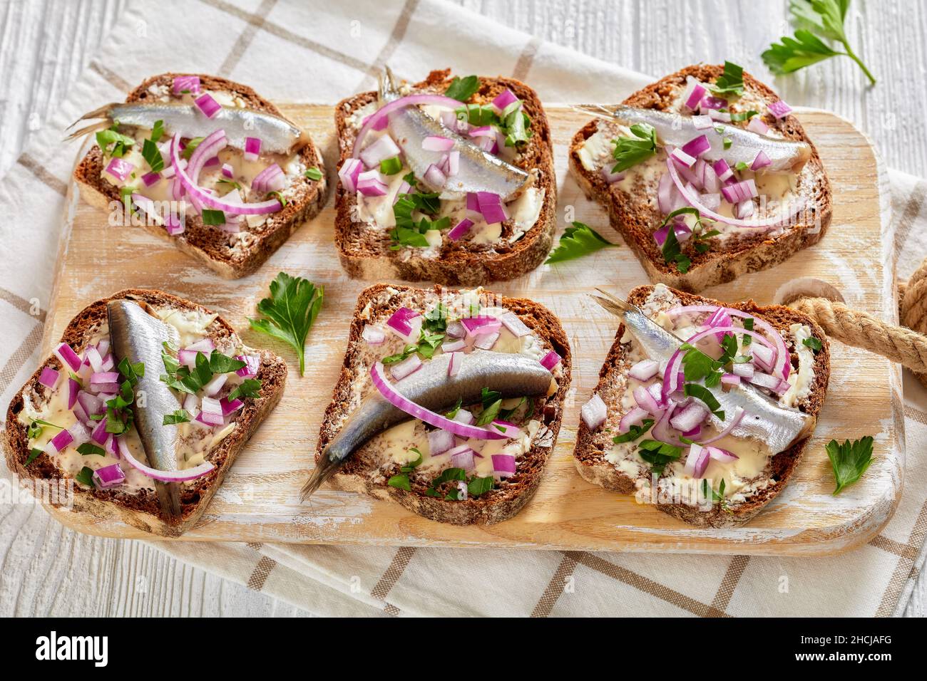 pickled sprat open sandwiches with butter and red onion on rye bread ...