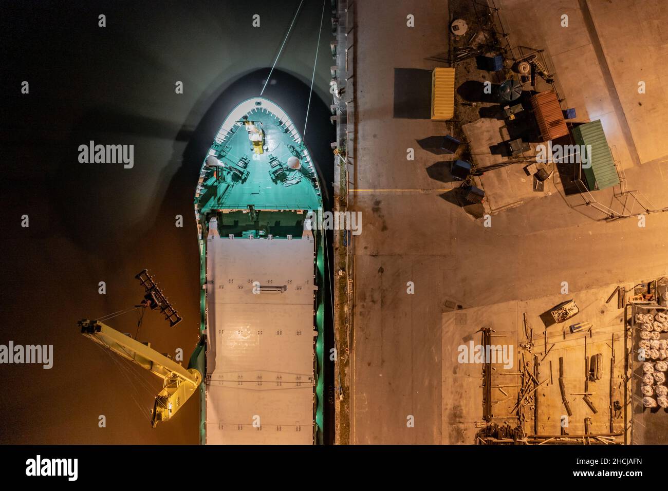 Ship Offloading Cargo at Docks at Night Stock Photo - Alamy