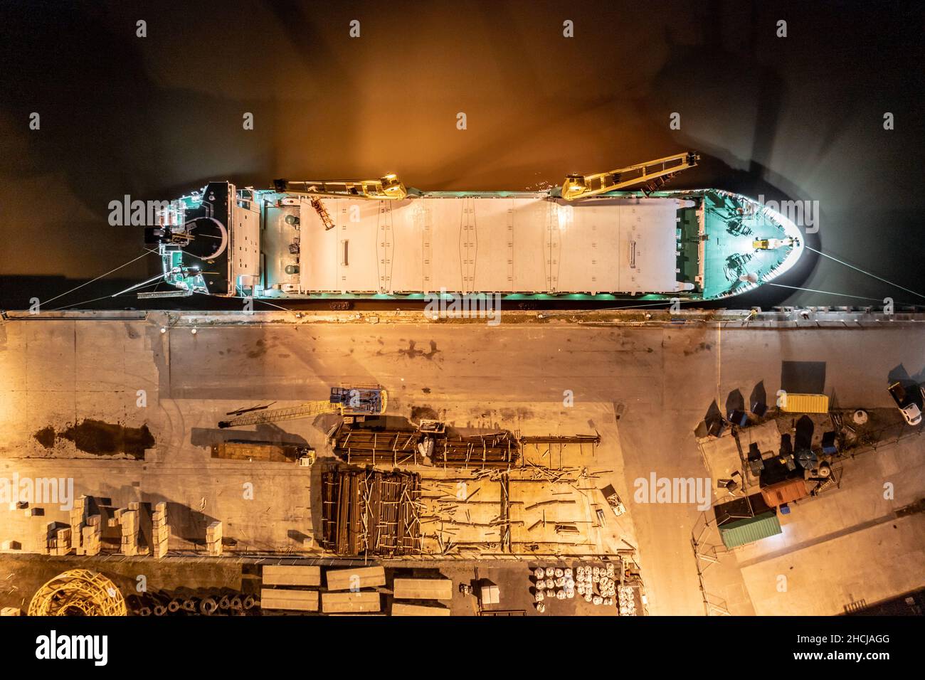 Ship Offloading Cargo at Docks at Night Stock Photo - Alamy