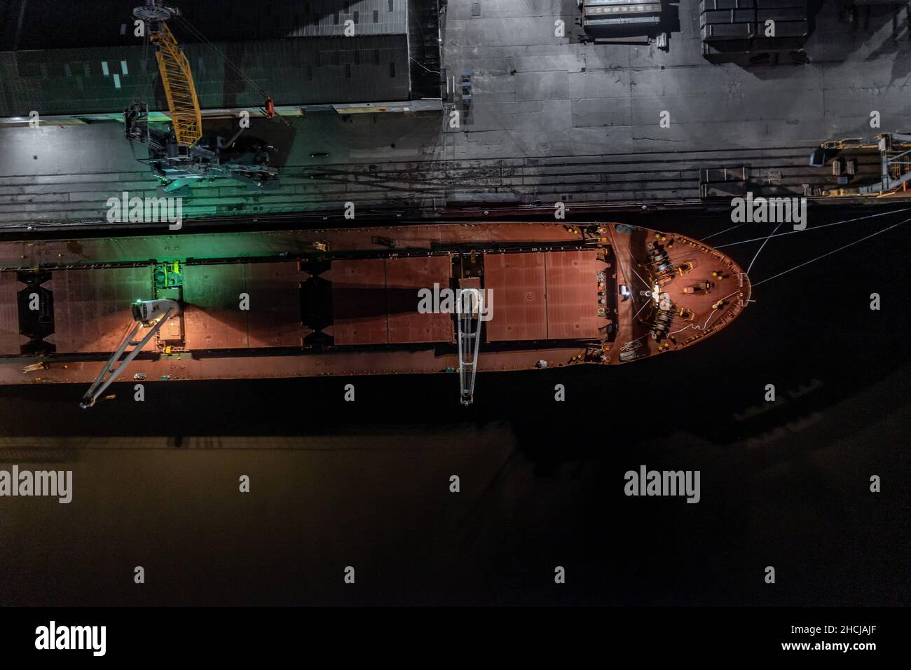 Ship Offloading Cargo at Docks at Night Stock Photo - Alamy