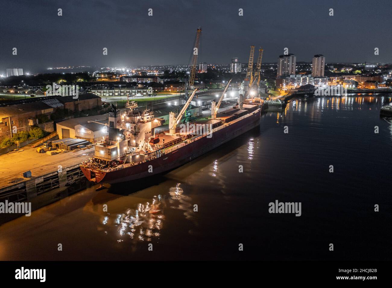 Ship Offloading Cargo at Docks at Night Stock Photo - Alamy