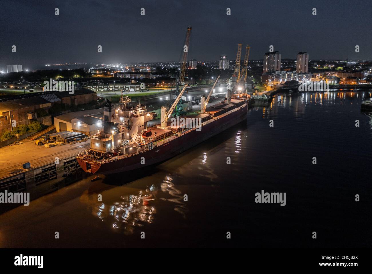 Ship Offloading Cargo at Docks at Night Stock Photo - Alamy