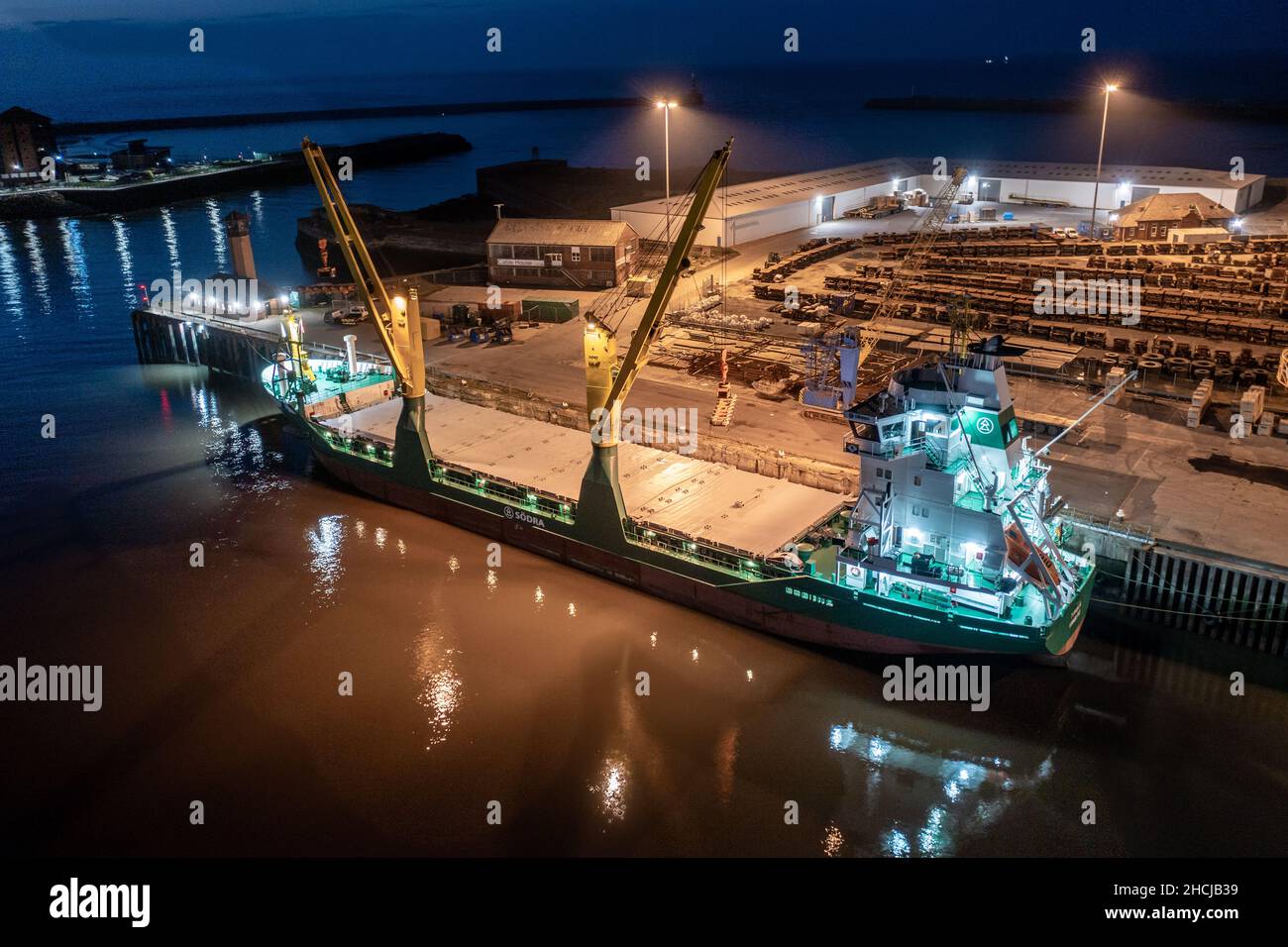 Ship Offloading Cargo at Docks at Night Stock Photo - Alamy