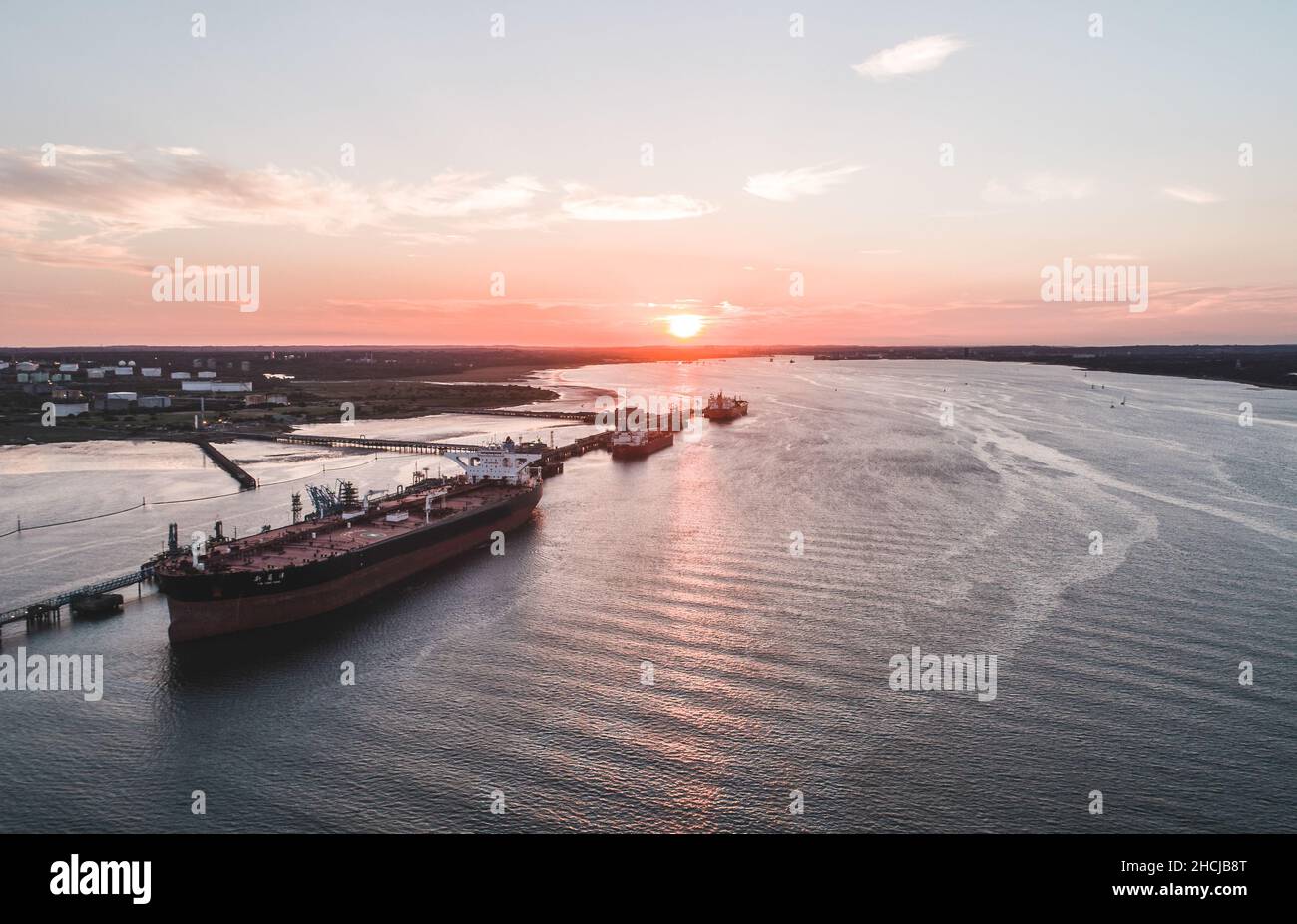 Oil Tanker Ships Docked at Sunset Stock Photo - Alamy