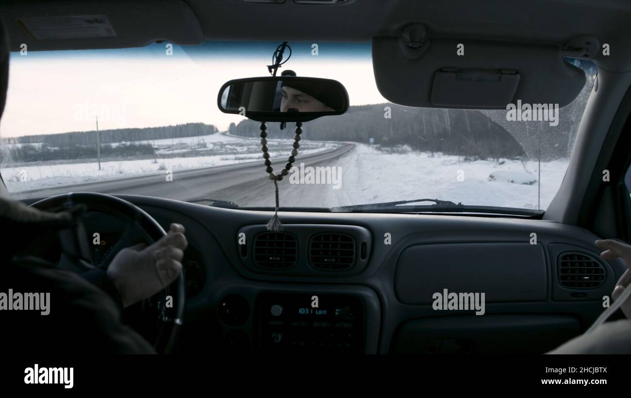 Car interior and winter road. Footage. Driver and passenger view from ...
