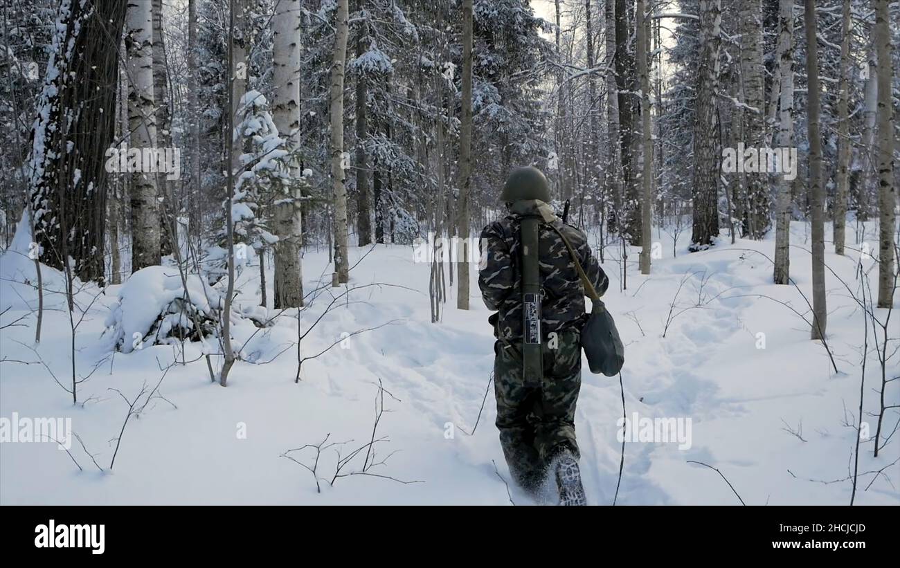 Soldier with weapons in cold forest. Winter warfare and military ...