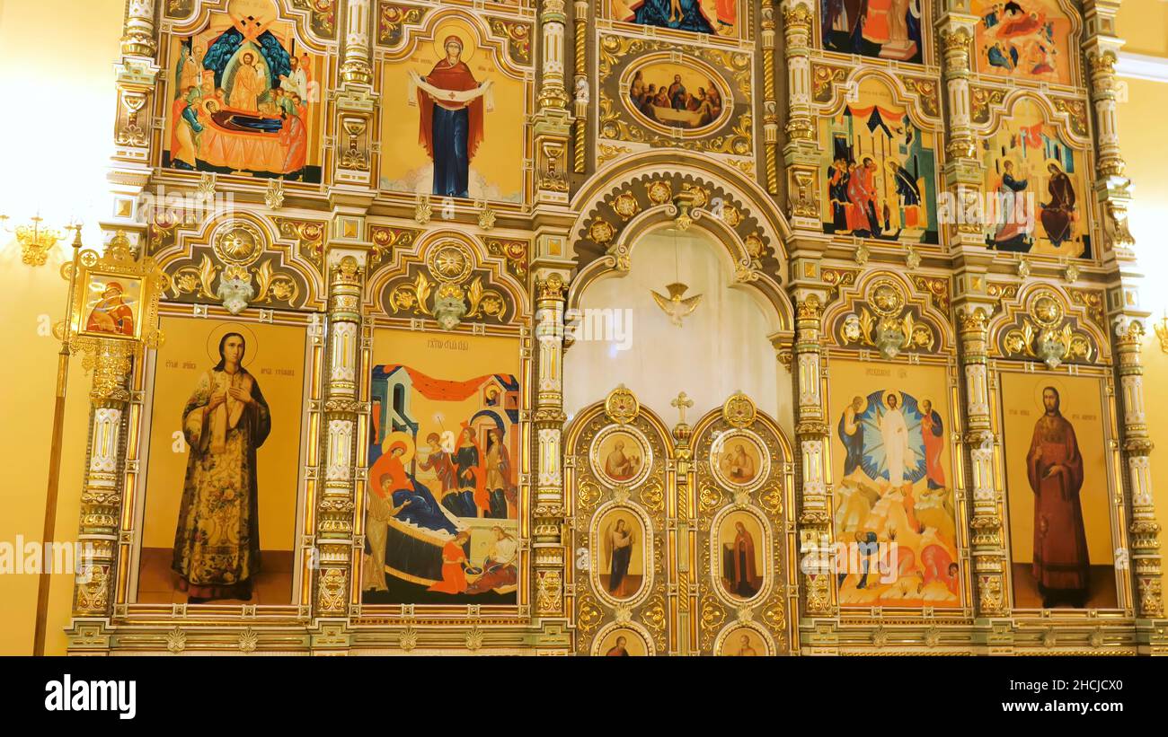 View inside of the Orthodox church with gold iconostasis showing biblical stories, religion ...