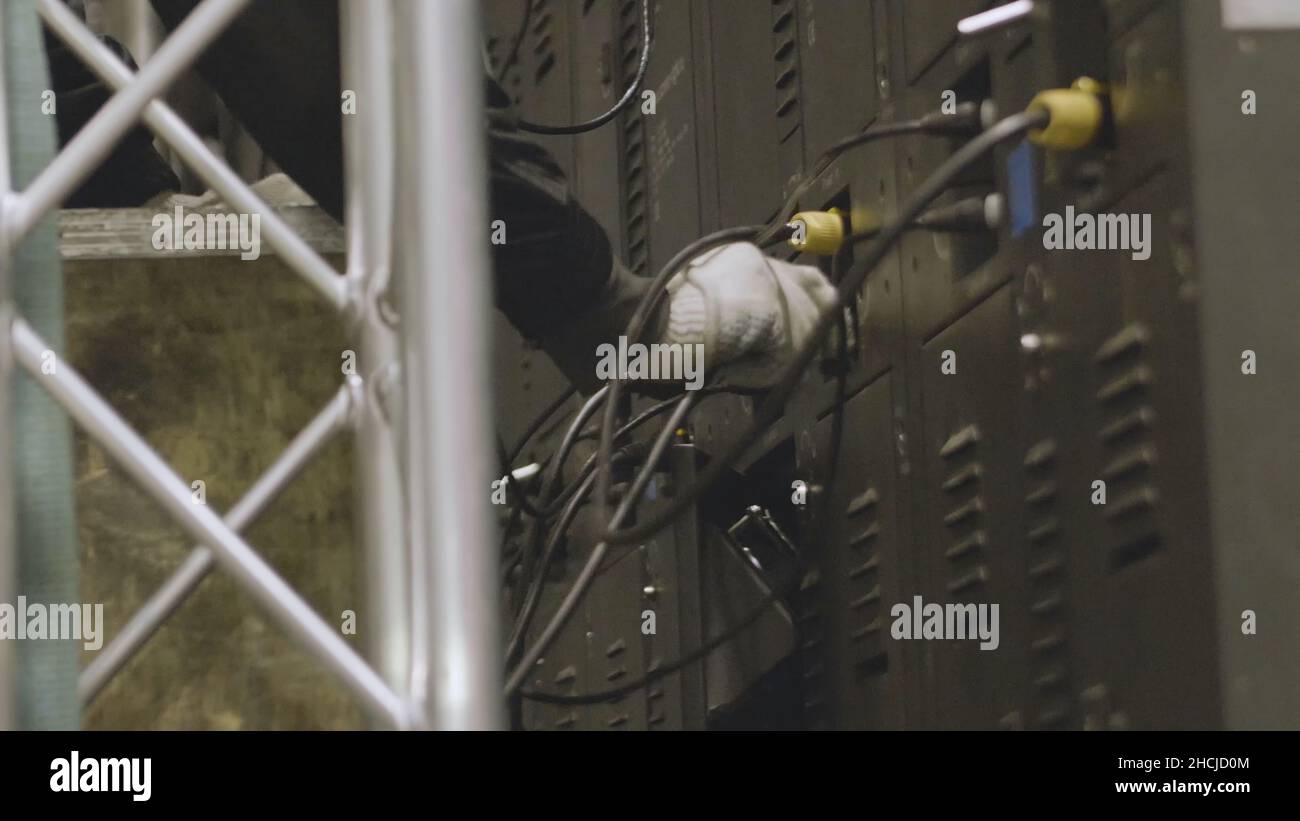 Electrician engineer tests electrical installations and wires on relay ...