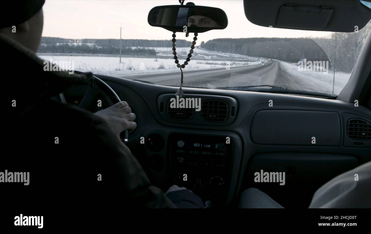Car interior and winter road. Footage. Driver and passenger view from ...