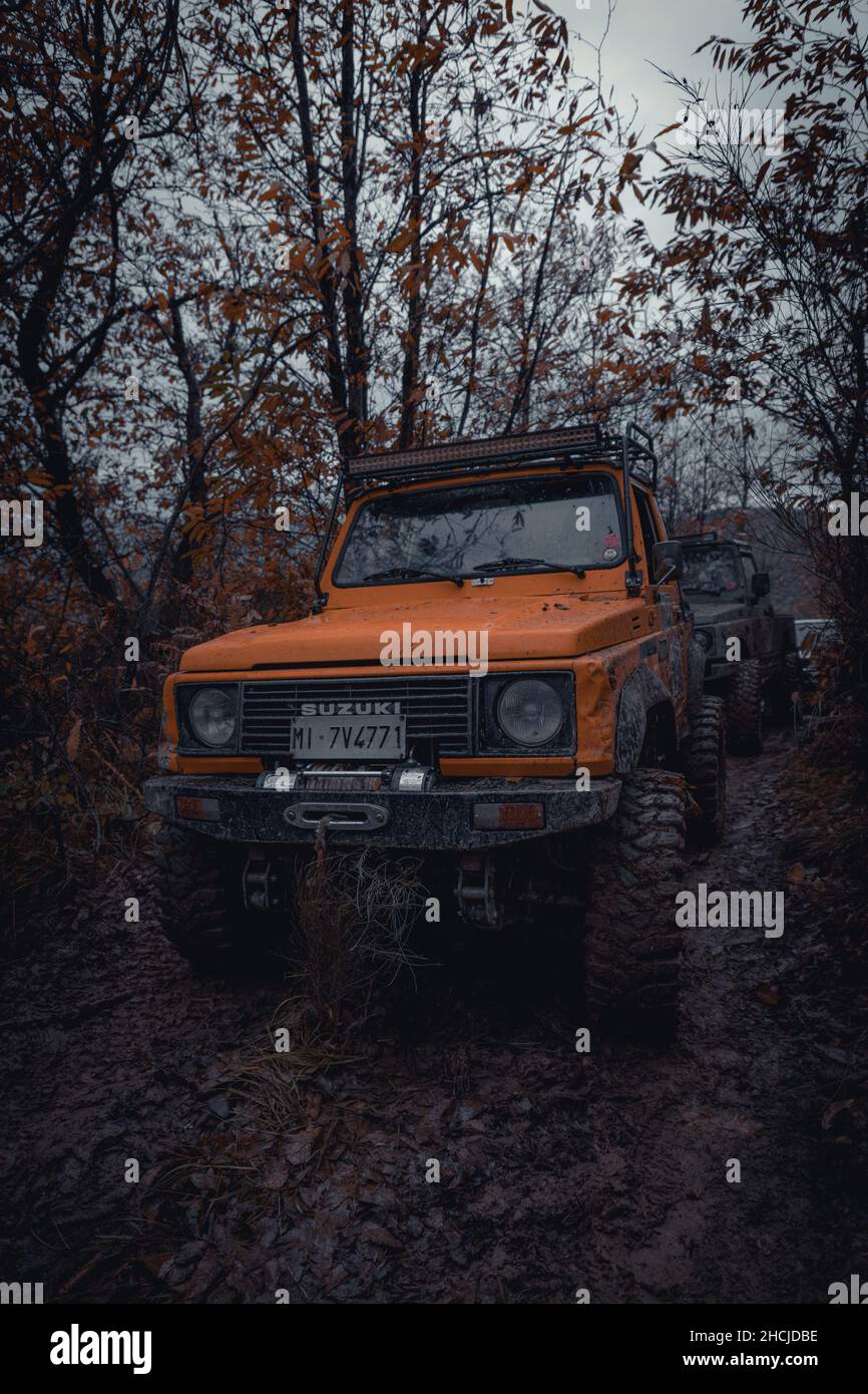Off-road black car driving in the dark forest Stock Photo - Alamy