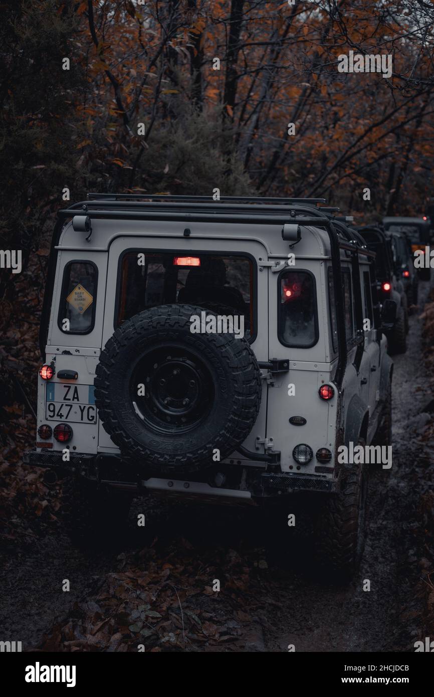 Off-road black car driving in the dark forest Stock Photo - Alamy
