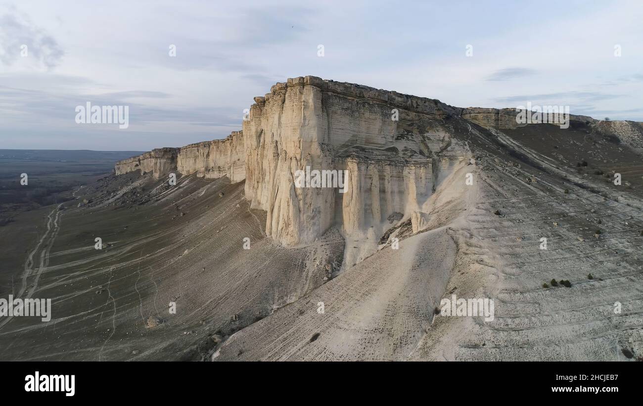 Aerial for breathtaking white cliff near green valley on beautiful ...