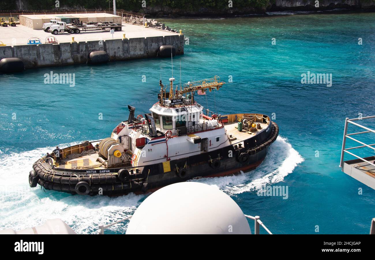 211228-N-MD461-1399 NAVAL BASE GUAM (Dec. 28, 2021) A tug boat prepares ...