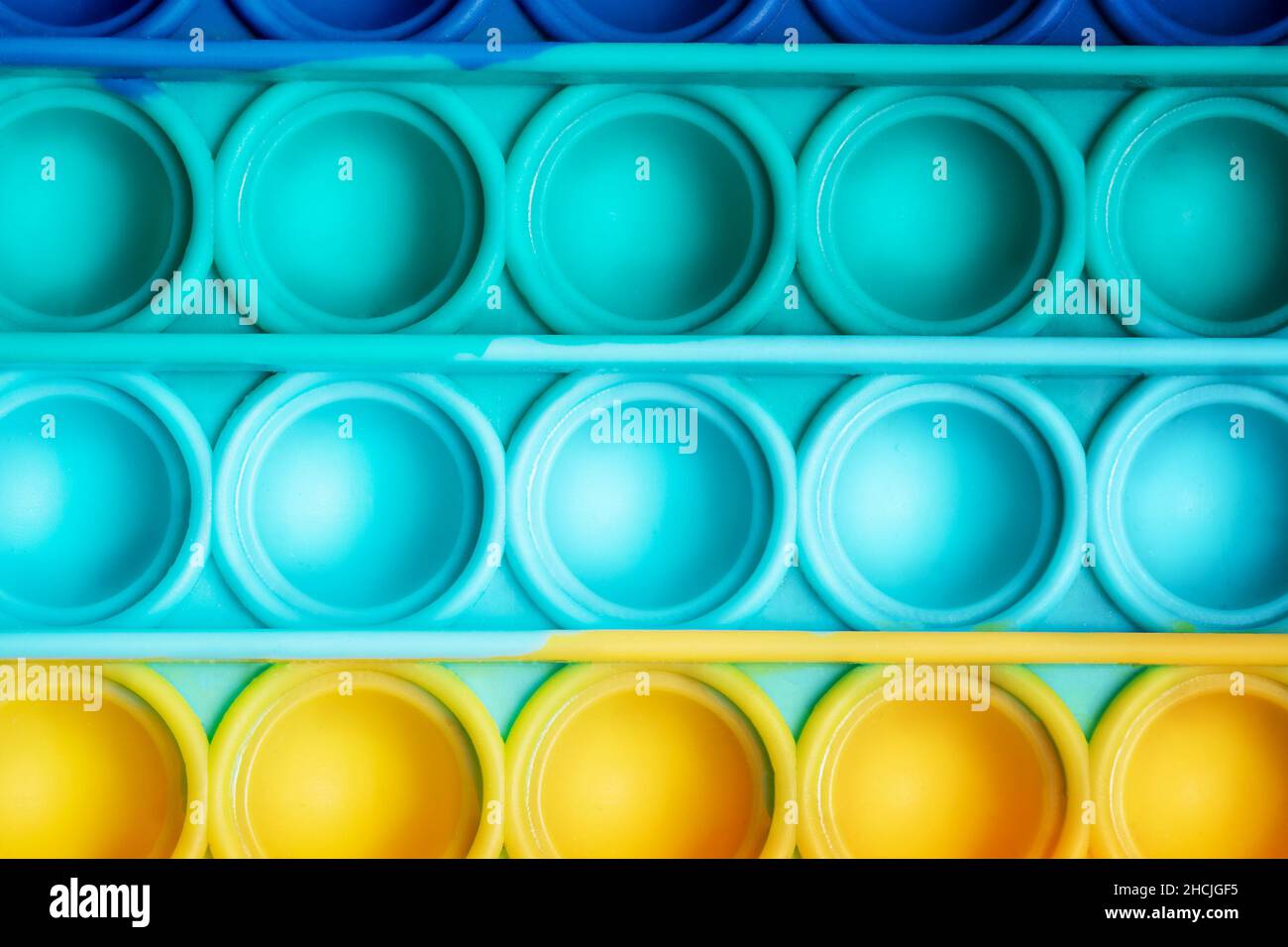 Colorful silicone pop pushing toy background Stock Photo - Alamy