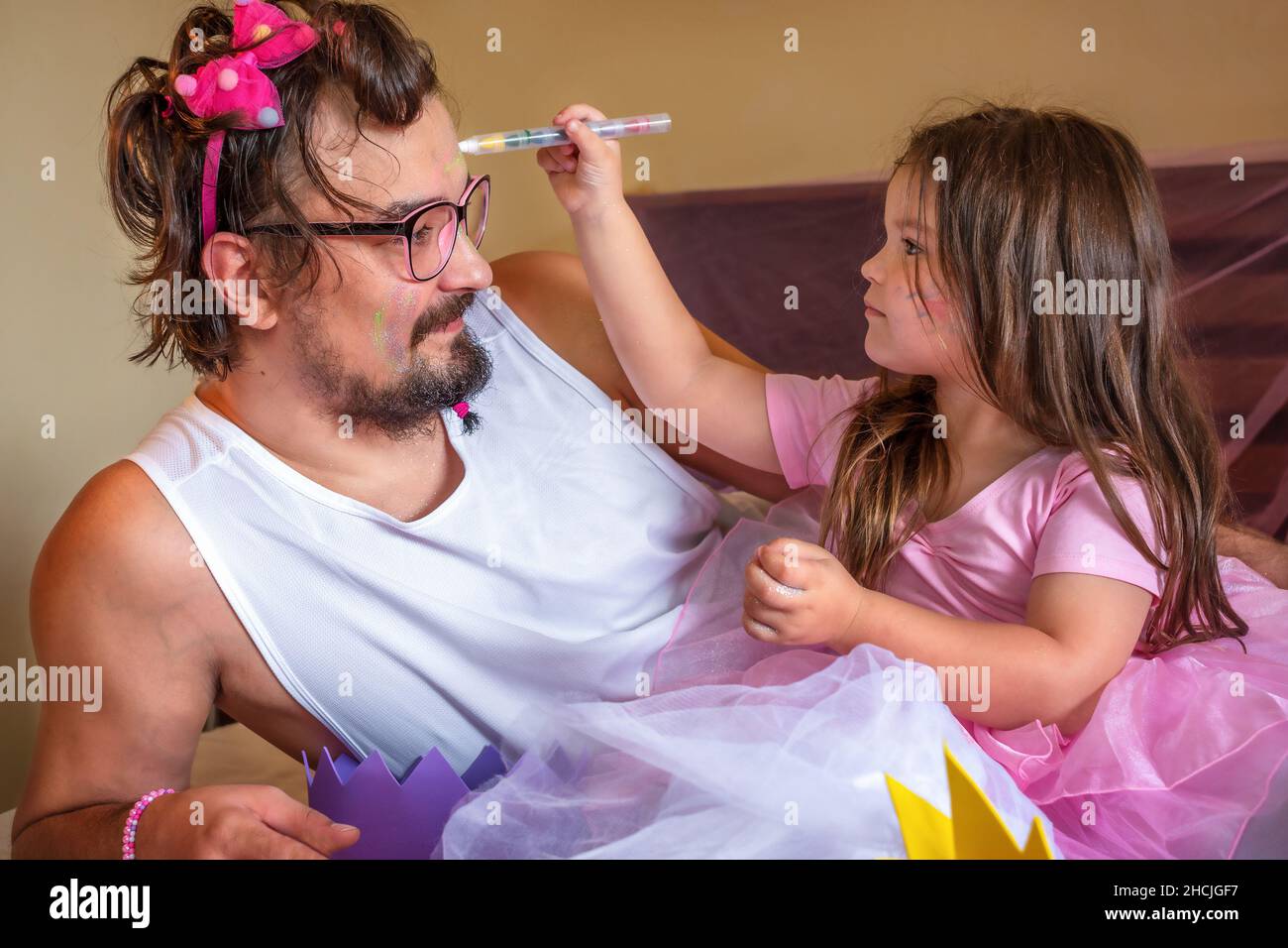 A girl dressed as a princess decorates dad. Games for girls with dad ...