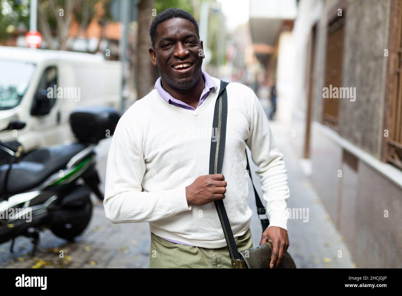 African american adult man walking to work along street Stock Photo - Alamy