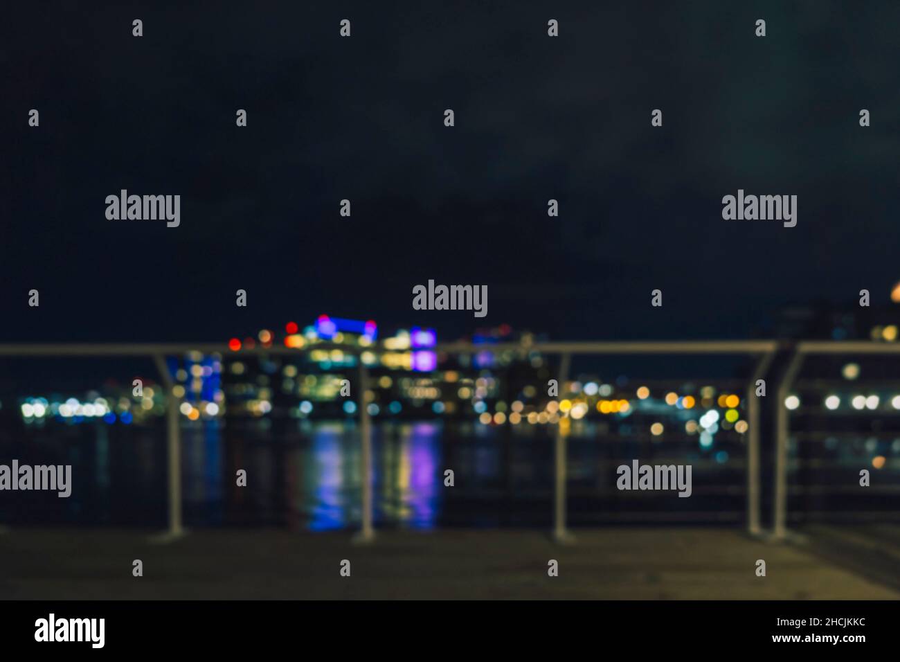 Bokeh background of Boston Harbor at night. Blurred city lights in the ...