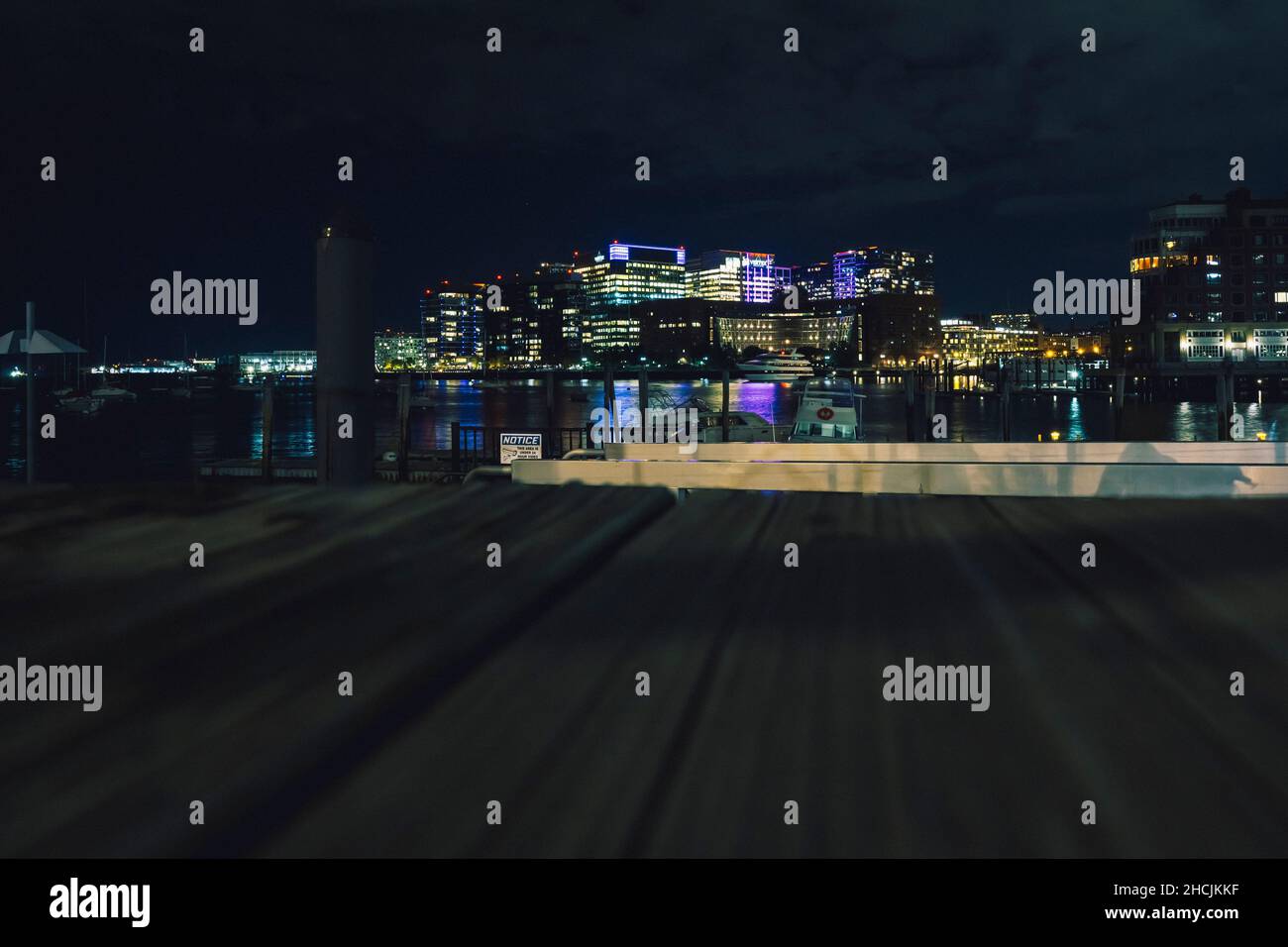 View of lights in the buildings at night seen from Boston Harbor deck ...