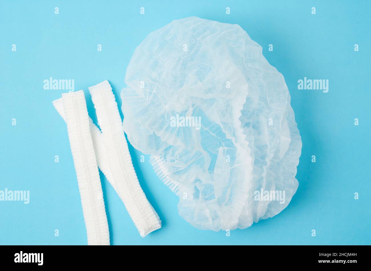 The white medical disposable cap on blue background Stock Photo - Alamy