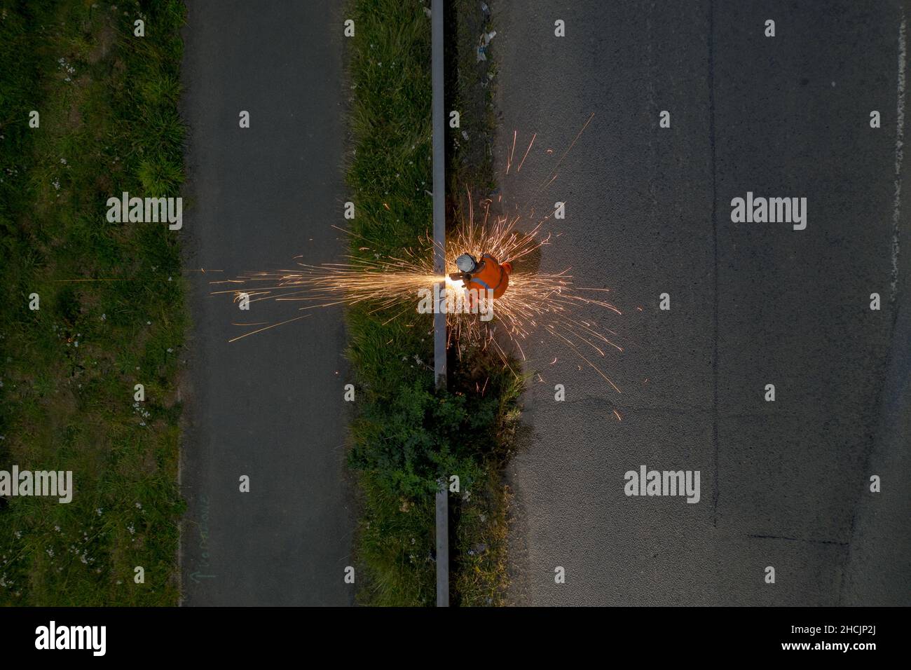 Motorway Worker Cutting Metal Bird's Eye View Stock Photo - Alamy