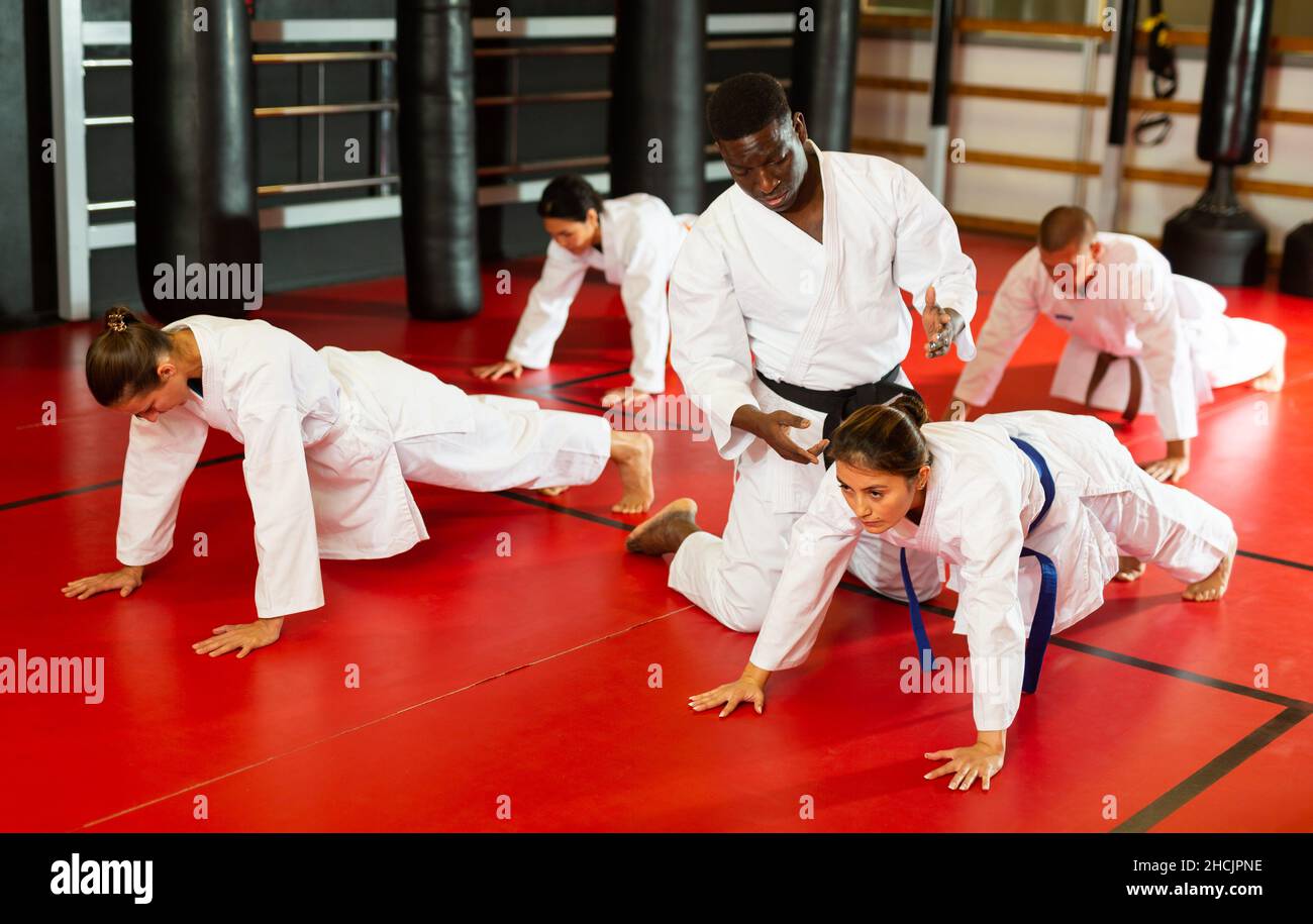 Training group of athletes before karate training - push-ups and muscle ...