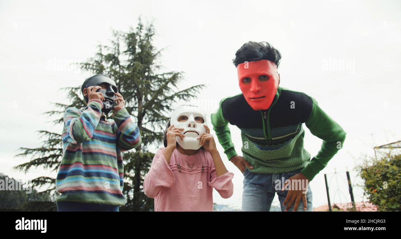 Group of young Indian kids with funny face masks posing on the balcony ...