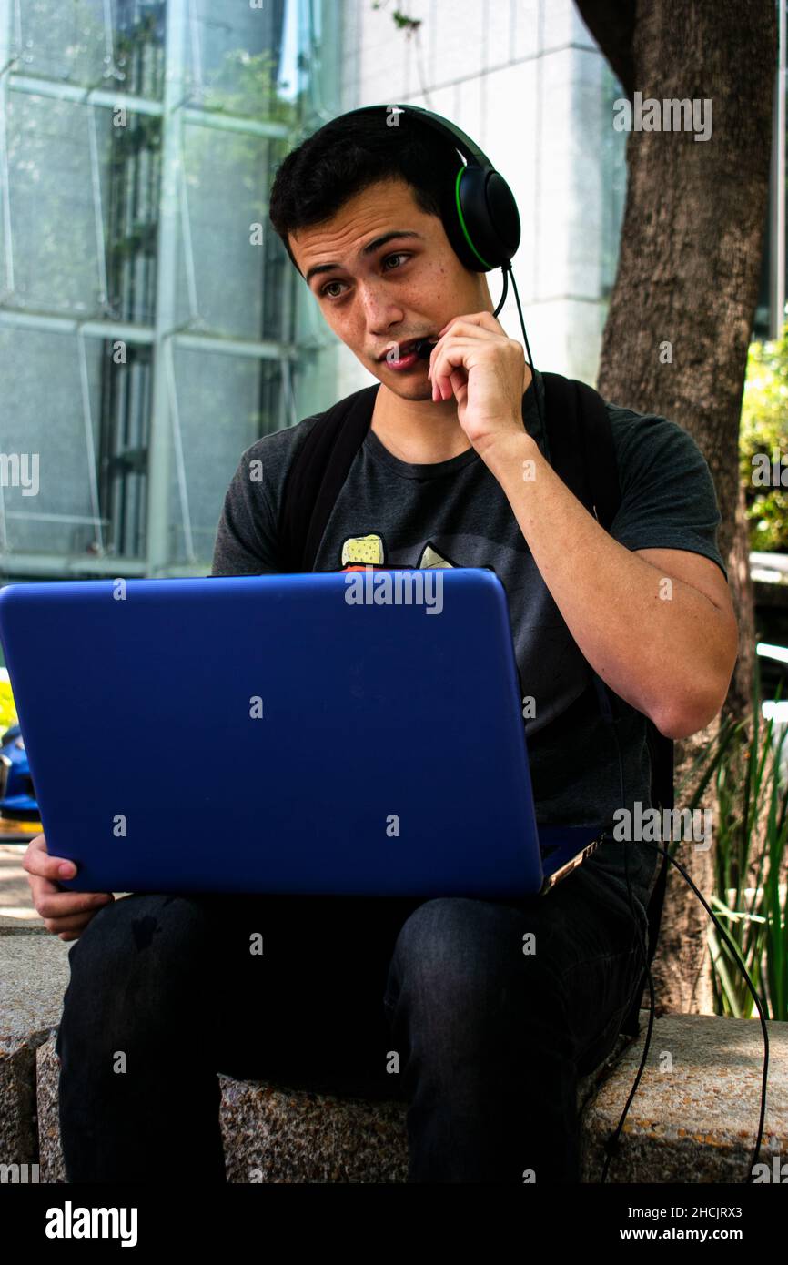 Boy talking outdoor with headsets with mic Stock Photo - Alamy