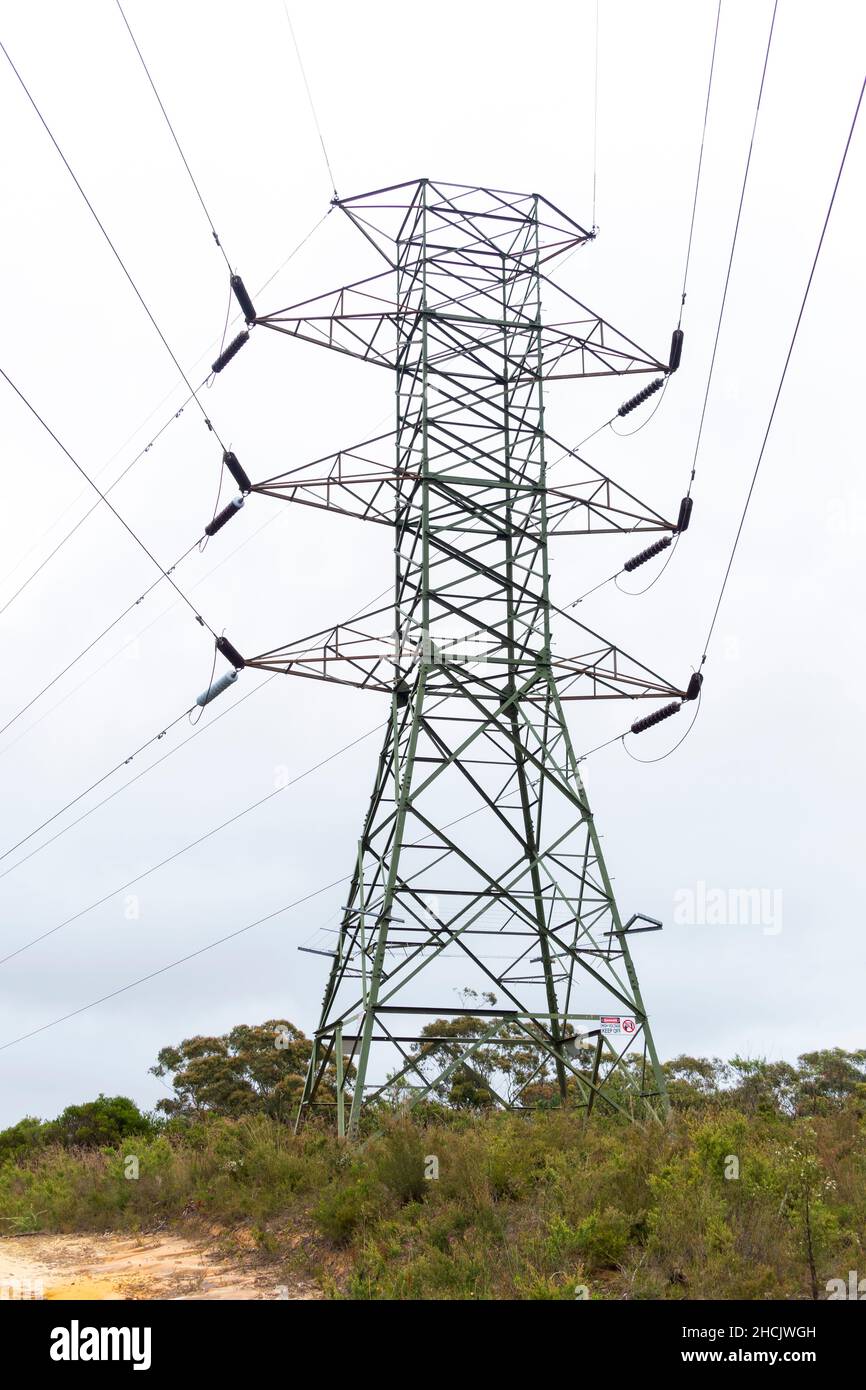 Photograph of a large steel electrical transmission tower near a dirt ...
