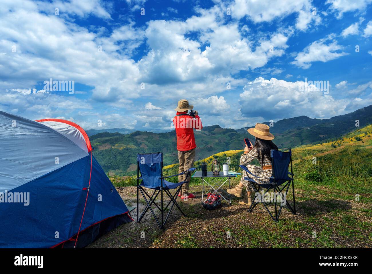 Couple tourists enjoying in the camping on mountains, Traveler take a ...