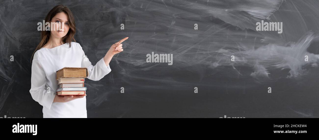 Focused university girl lecturer near blackboard student or teacher in ...