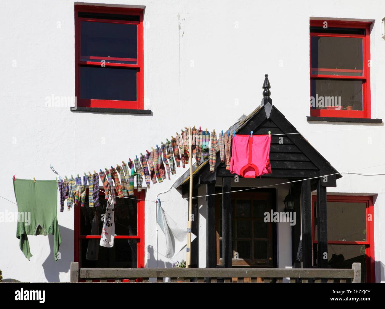Colourful washing line outside cottage Stock Photo - Alamy