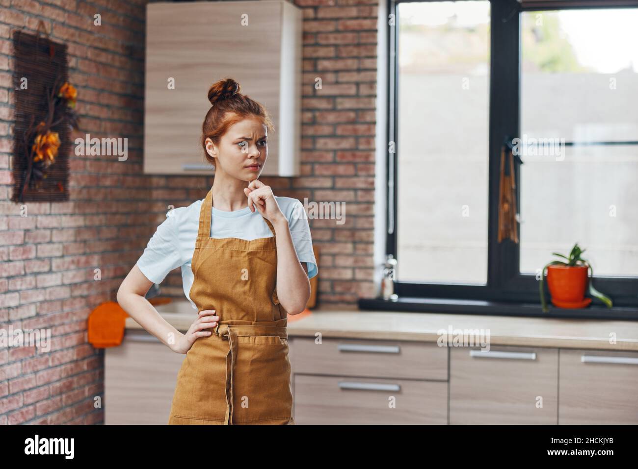woman houses in the kitchen gestures with his hands apartments ...