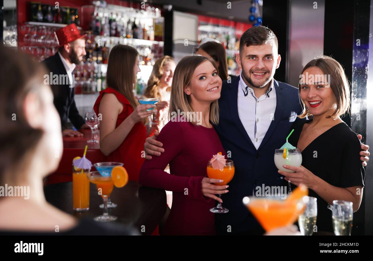 Man and two women at nightclub Stock Photo - Alamy