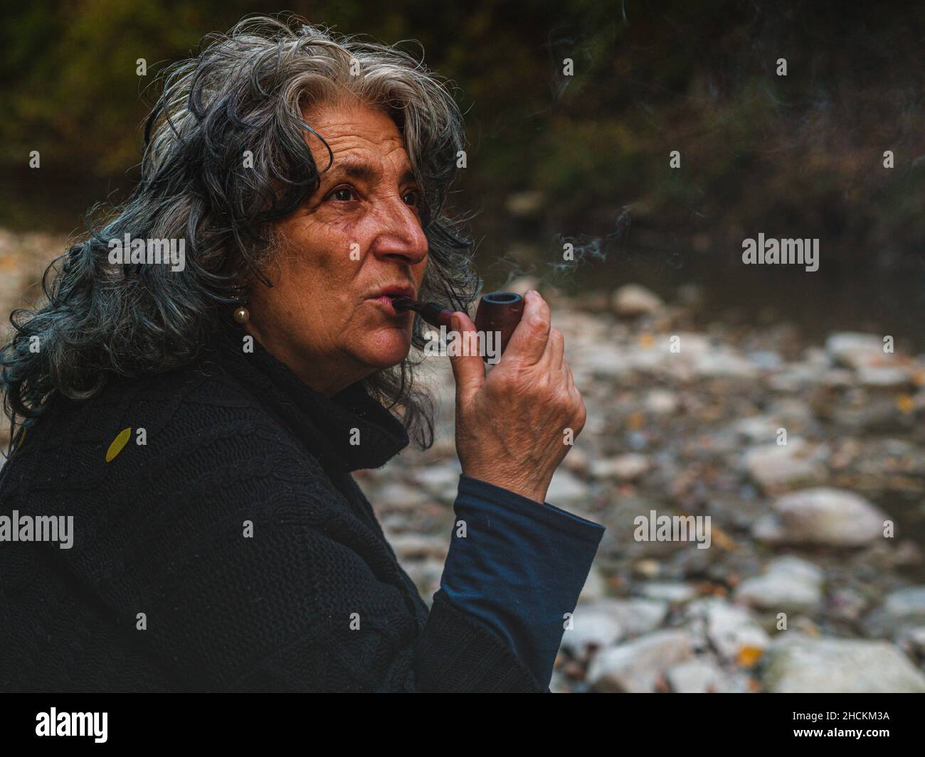 Old woman smoking pipe hi-res stock photography and images - Alamy