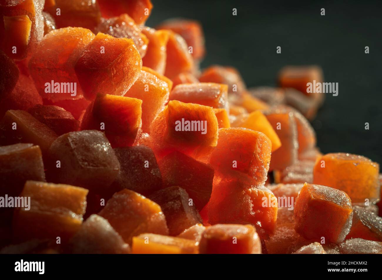 Frozen fresh carrot cube pieces closeup background Stock Photo - Alamy