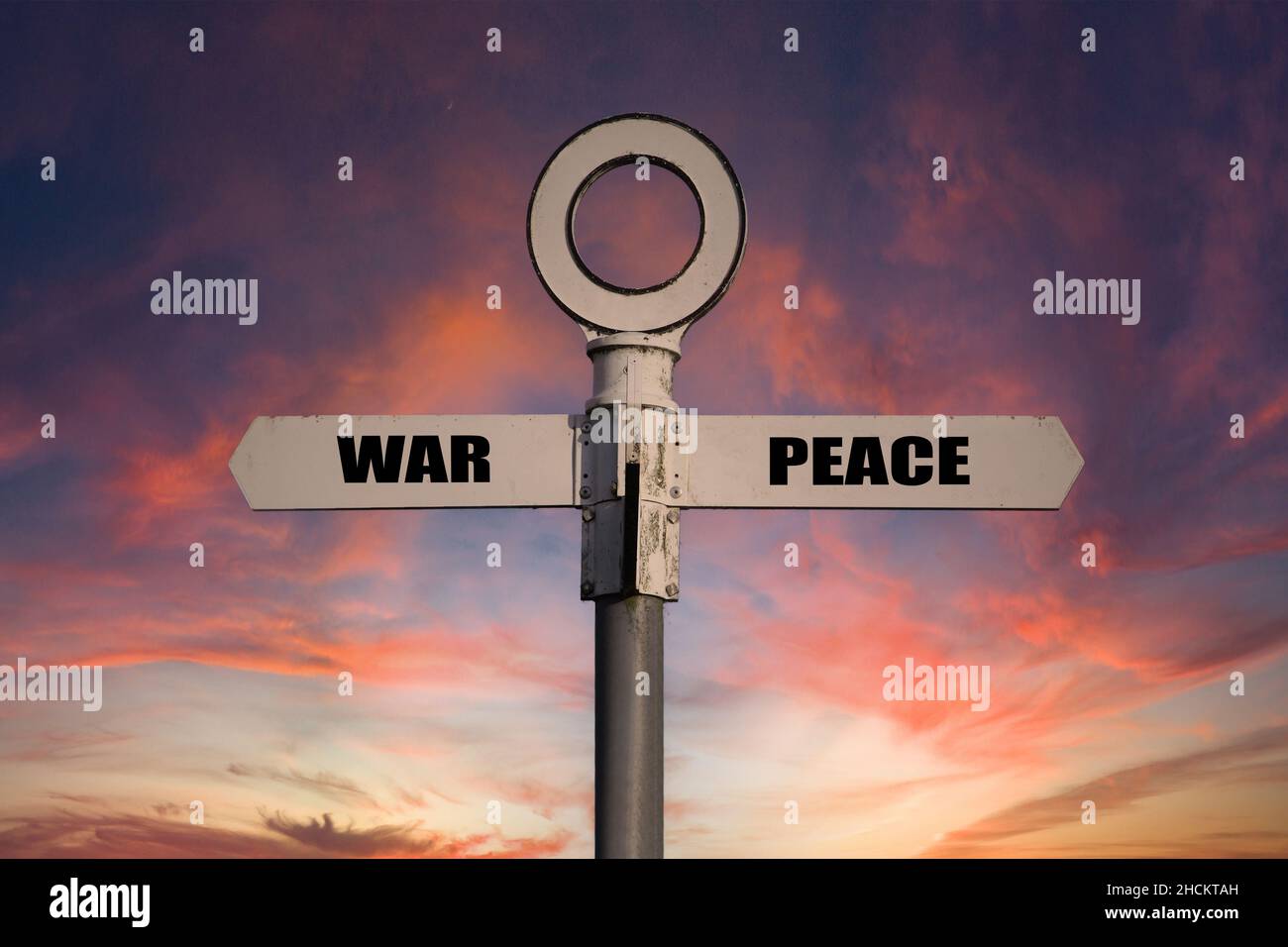 Old road sign with war and peace pointing in opposite directions. Pro ...
