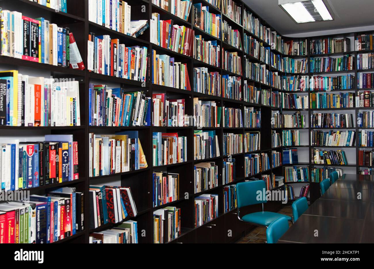 Many colored books lying on shelves in reading room in library Stock ...