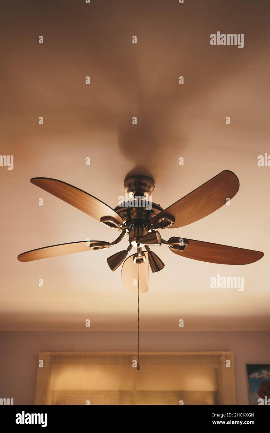 Wooden roof fan inside a home Stock Photo - Alamy