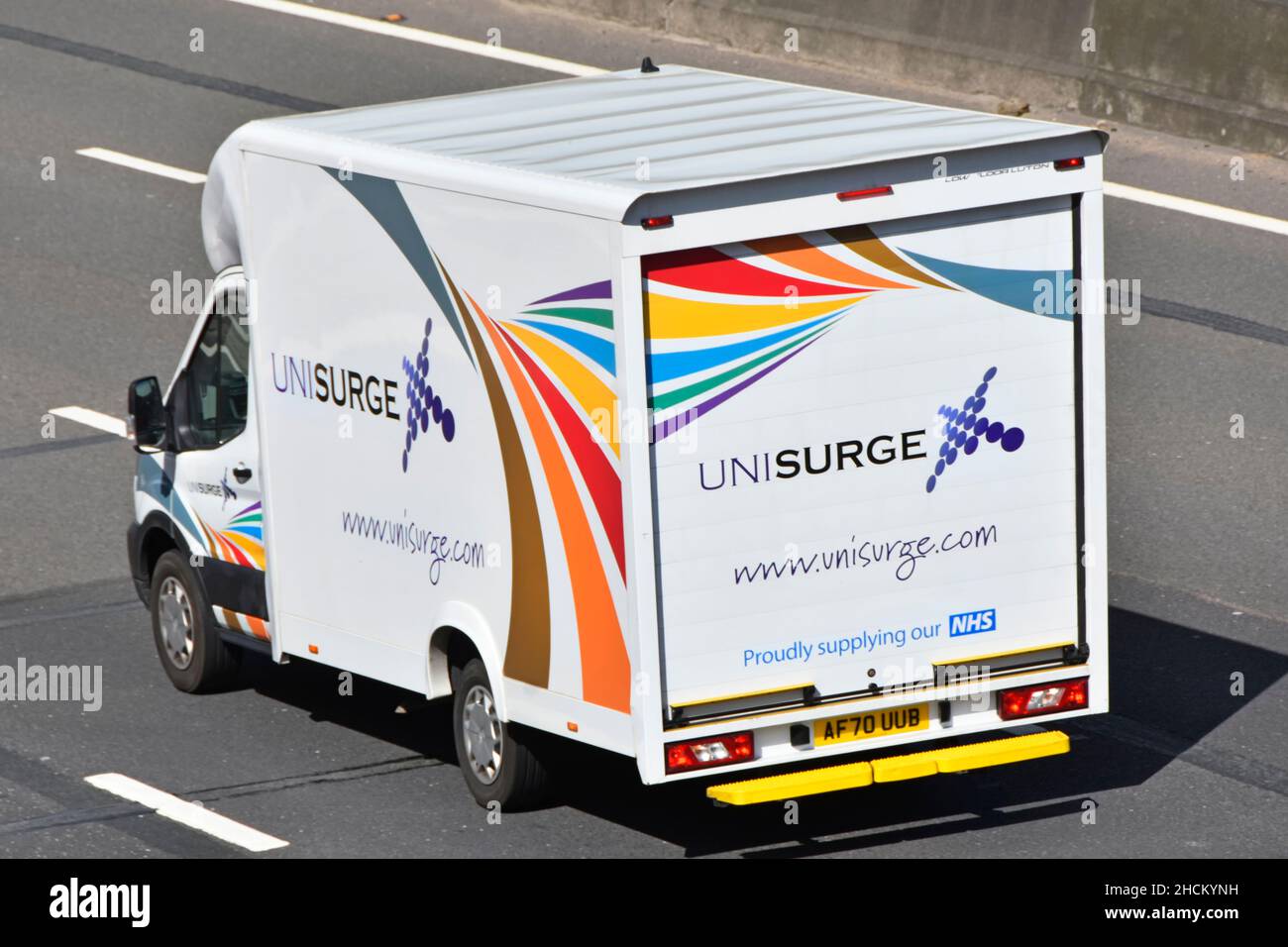 Colourful graphics on side view & back roller shutter of small lorry ...