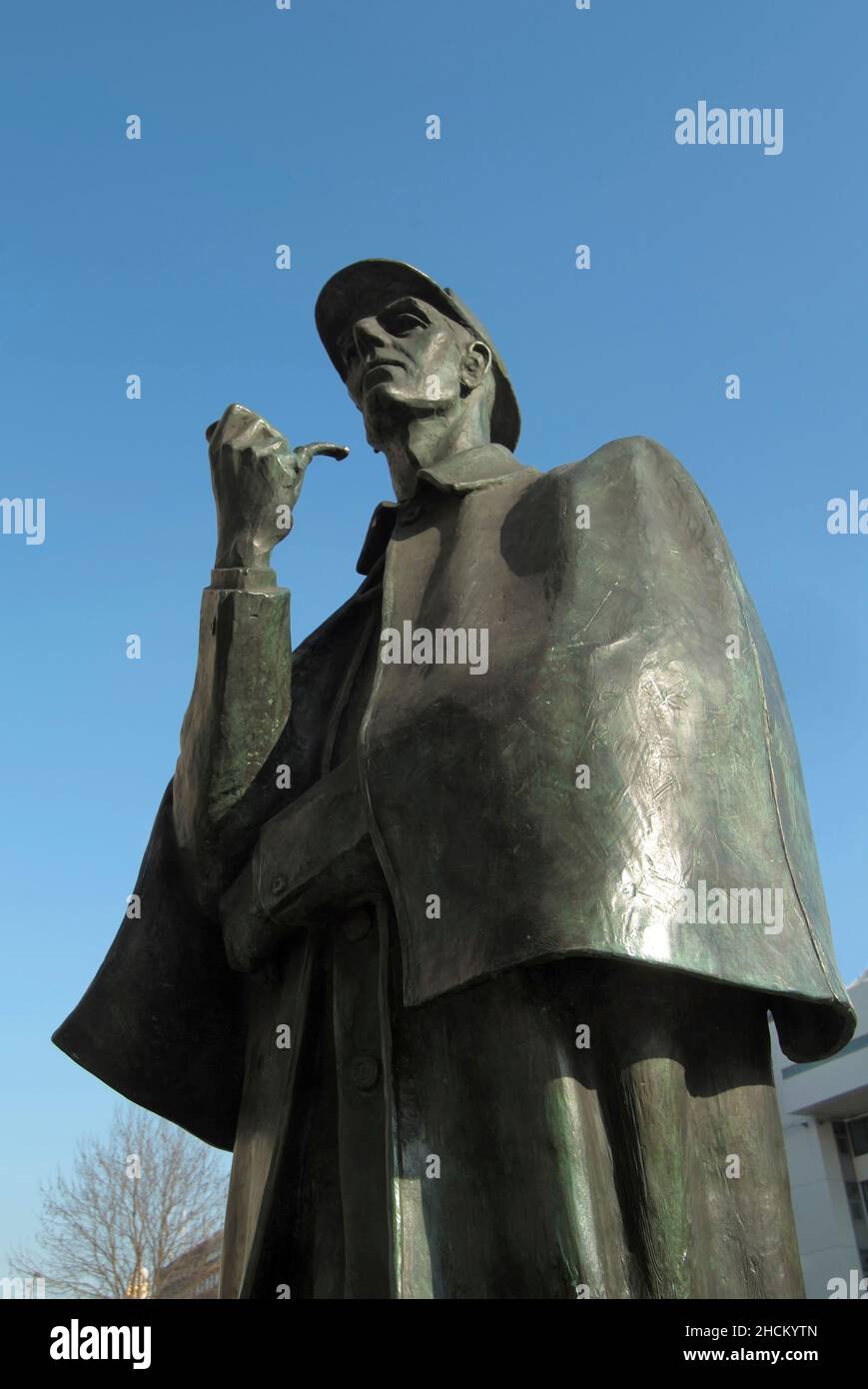Close up angled skywards view of pipe cloak face & hat part of Sherlock ...