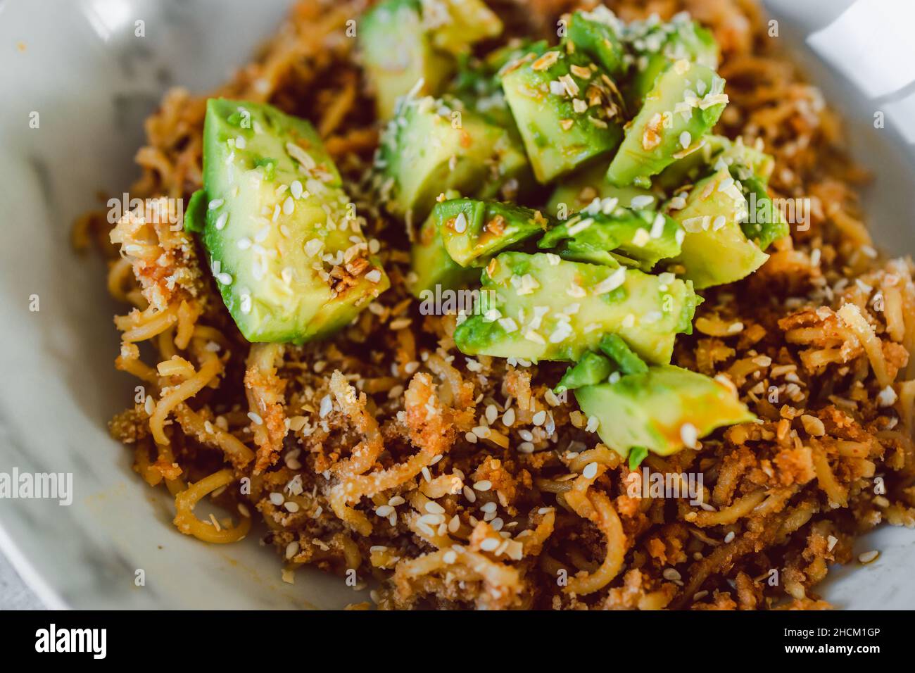 vegan ginger noodles with avocado sesame and fried onion topping ...