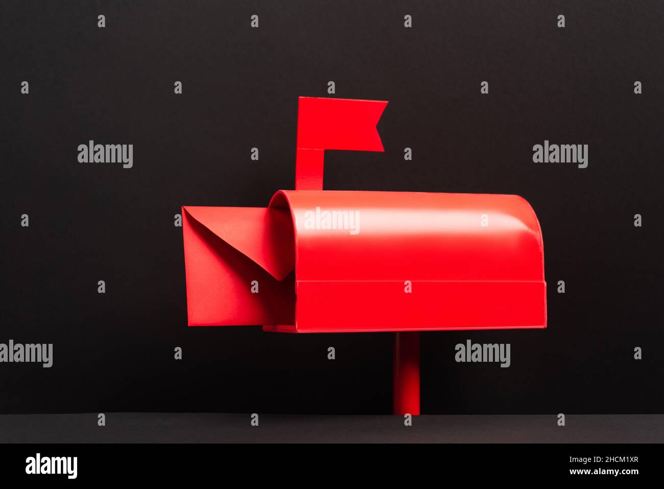 red envelope in metallic post box on black Stock Photo - Alamy