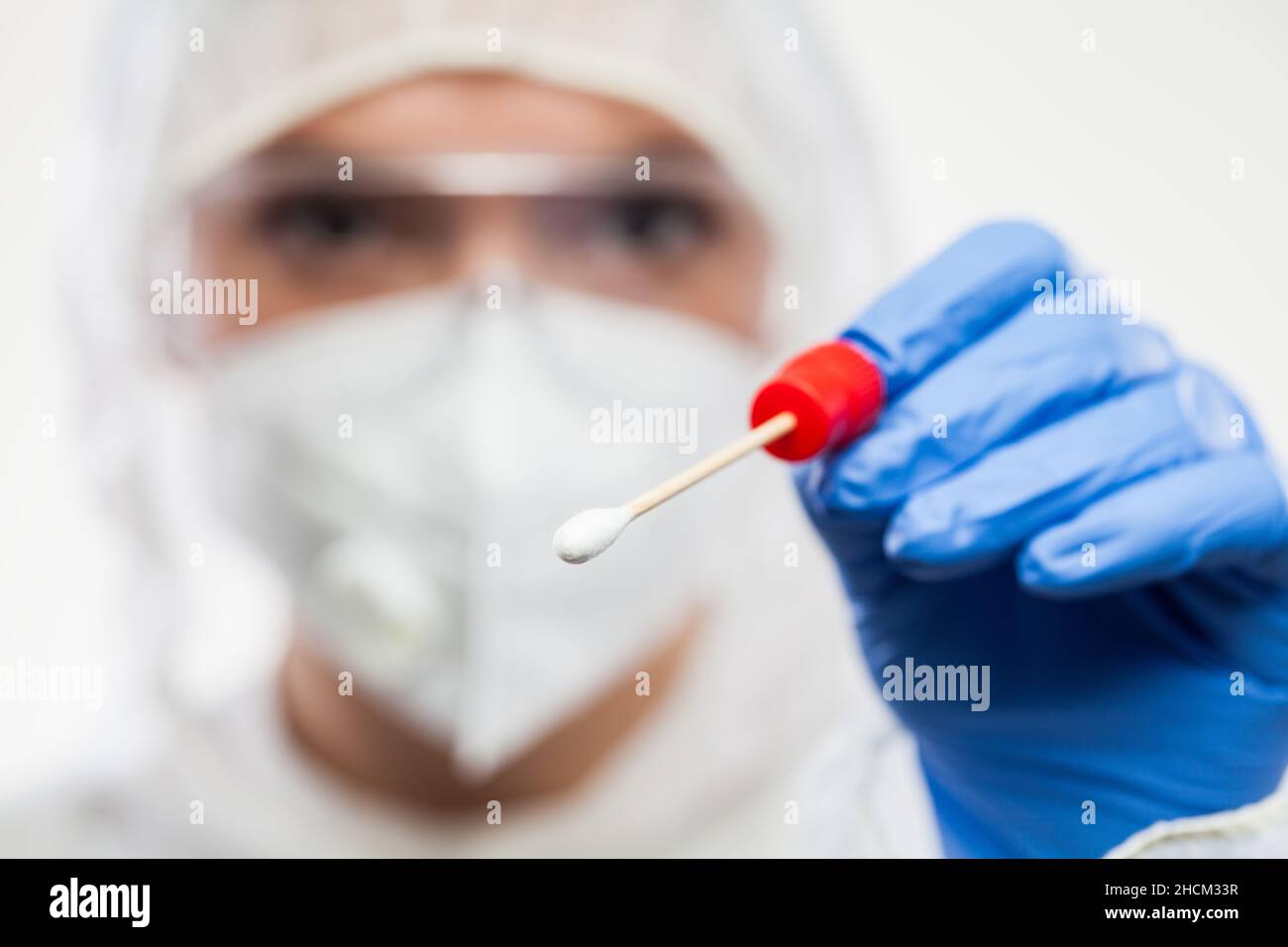 Female medical worker holding cotton swab sample stick for collecting ...