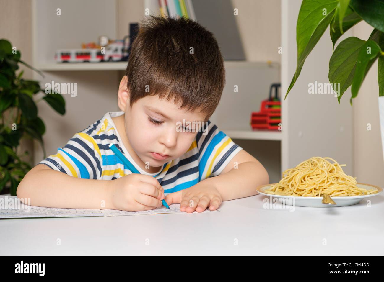 Preschool child learns to write, writes copybook Stock Photo - Alamy