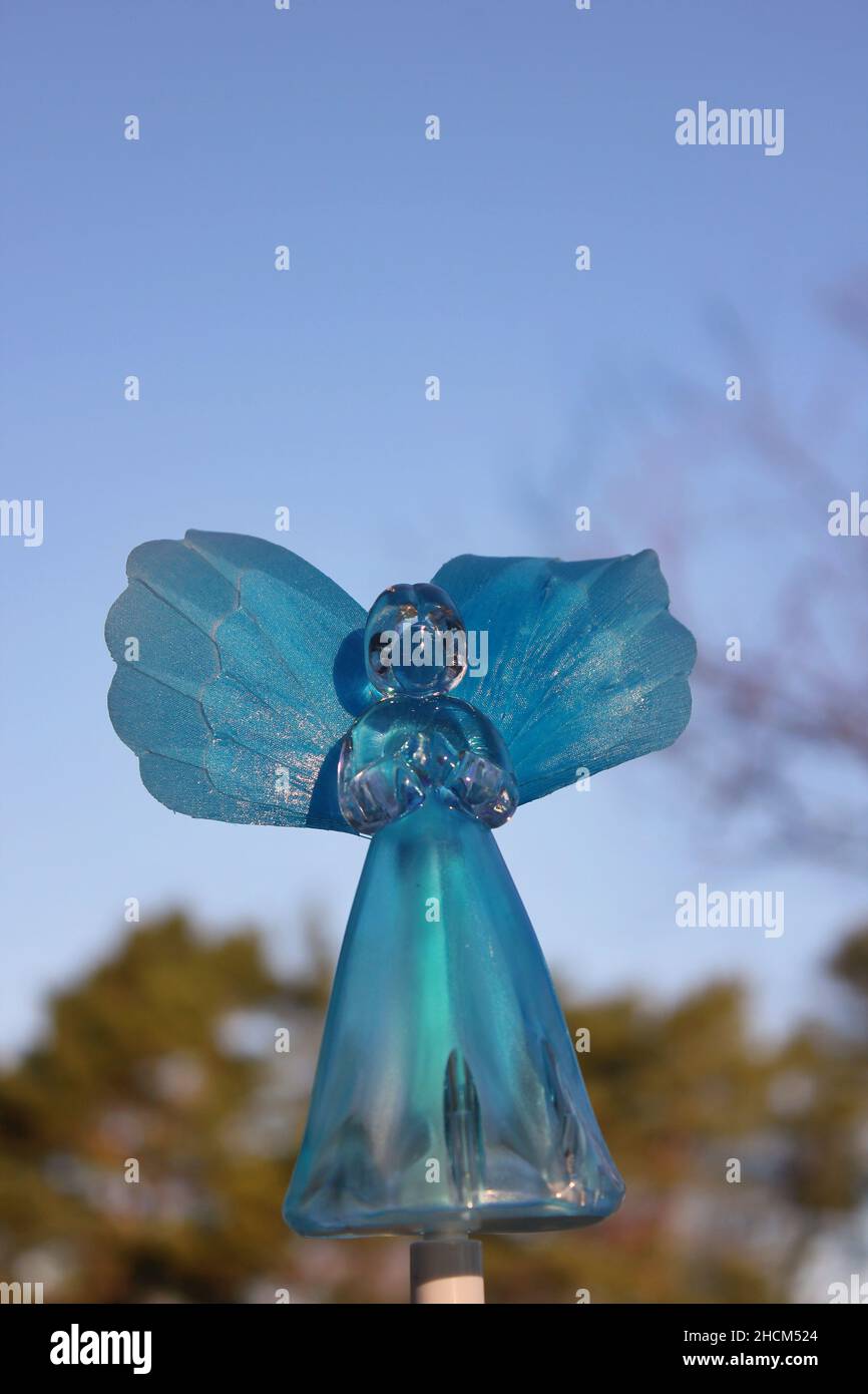 Blue angel guardian holding her hands in prayer Stock Photo - Alamy